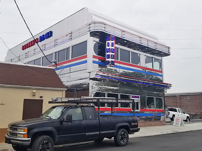 The gleaming chrome exterior of Goobers Diner stands like a time machine to the 1950s, complete with those iconic red and blue stripes that practically scream "great breakfast inside!"