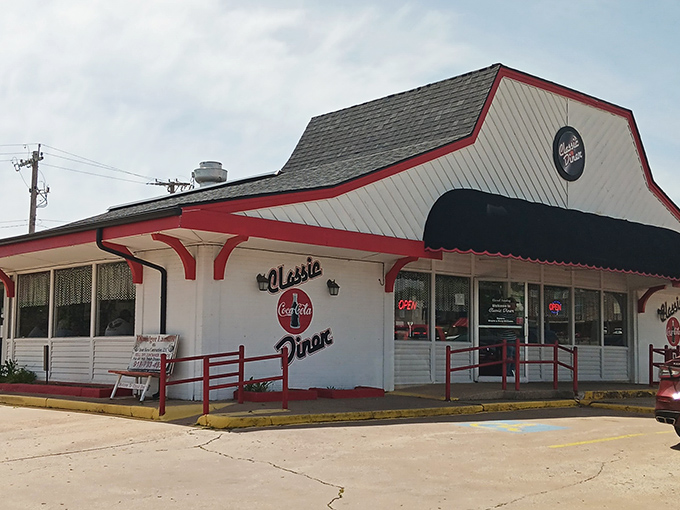 The red and white exterior of Classic Diner stands like a time capsule on Henryetta's landscape, beckoning hungry travelers with its vintage charm and glowing "OPEN" sign.