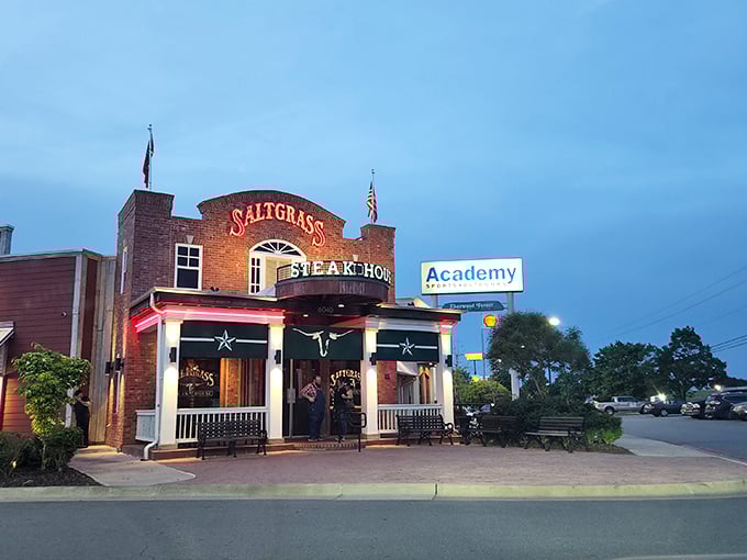 The brick facade of Saltgrass stands like a beacon of hope for hungry travelers. Those flags aren't just decoration&mdash;they're dinner semaphore.