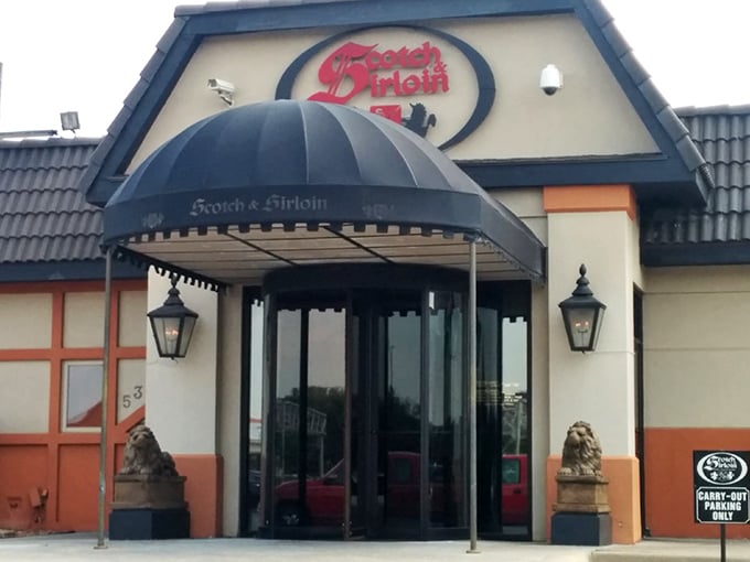 The iconic entrance to Scotch & Sirloin, where those stone lions aren't just guarding the door&mdash;they're keeping the vegetarians at bay.