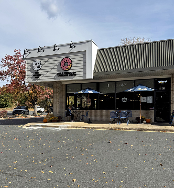 The pink donut sign beckons like a sugar-dusted lighthouse, guiding hungry travelers to this unassuming strip mall treasure in Wilmington.