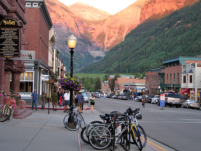 Colorado Avenue stretches toward mountain majesty, where Victorian charm meets alpine grandeur. Telluride's main street invites you to wander and wonder.