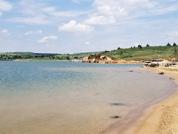 Nature's perfect meditation spot: where Kansas beach meets crystal waters, creating a moment of zen that no spa could replicate.