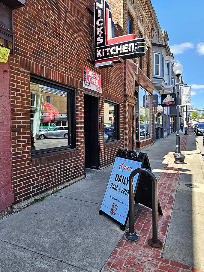 The iconic neon sign of Nick's Kitchen stands as a beacon of culinary history on Huntington's Jefferson Street. A century of tenderloin tradition lives behind this brick fa&ccedil;ade.
