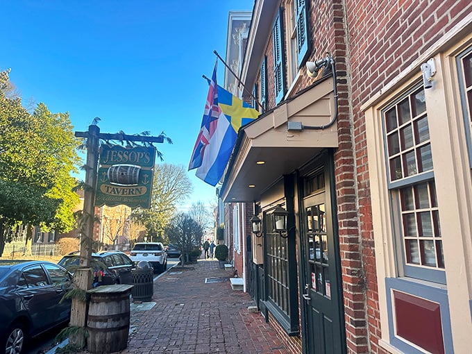 The historic fa&ccedil;ade of Jessop's Tavern welcomes you with colonial charm, international flags, and that wooden barrel that practically whispers, "Good times await inside."