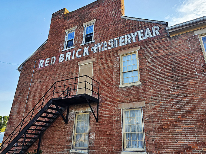 The historic facade of Red Brick Tavern stands proudly along Route 40, its weathered bricks whispering stories from nearly two centuries of serving hungry travelers.