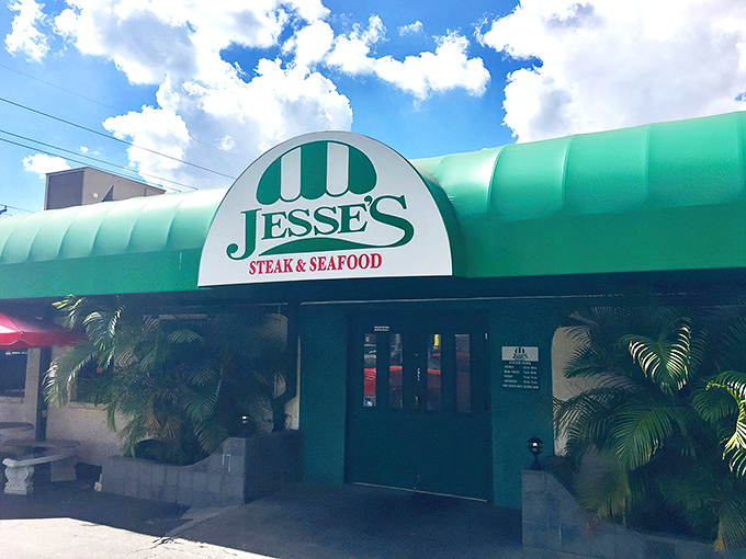 The iconic green awning of Jesse's Steak & Seafood stands as a beacon for hungry Floridians, promising old-school delights within those unassuming doors.