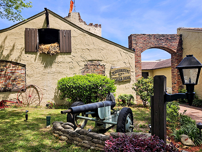 The fortress-like exterior of 57th Fighter Group stands ready for your culinary mission, complete with vintage artillery that's thankfully only targeting your appetite.