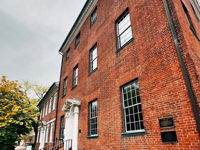 The stately brick facade of Gadsby's Tavern stands proudly in Old Town Alexandria, a colonial time capsule where history and hunger harmoniously collide.