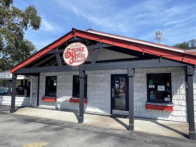 The red-roofed temple of smoke beckons with all the subtlety of a dinner bell, promising salvation through slow-cooked meats in coastal Southport. 