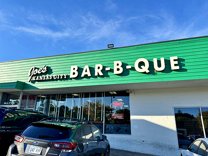 The emerald beacon of barbecue bliss! Joe's iconic green exterior stands as Kansas City's tastiest gas station conversion, promising smoky treasures within.
