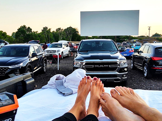 Twilight magic unfolds as cars gather beneath the massive screen, nature providing the perfect backdrop for cinema under an Ohio sunset.
