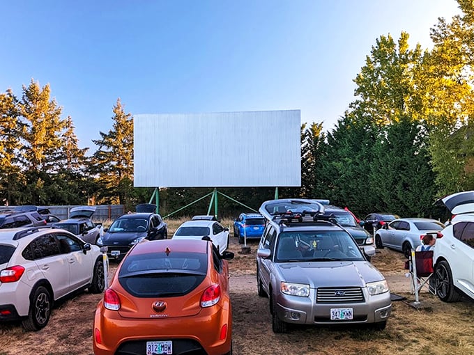 As twilight descends, cars line up facing the massive white screen, where cinematic dreams come alive under Oregon's star-studded sky.
