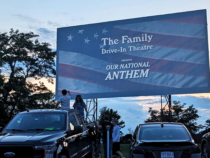 Twilight magic unfolds as cars gather beneath a pastel sky, the massive white screen waiting to transport viewers to another world.