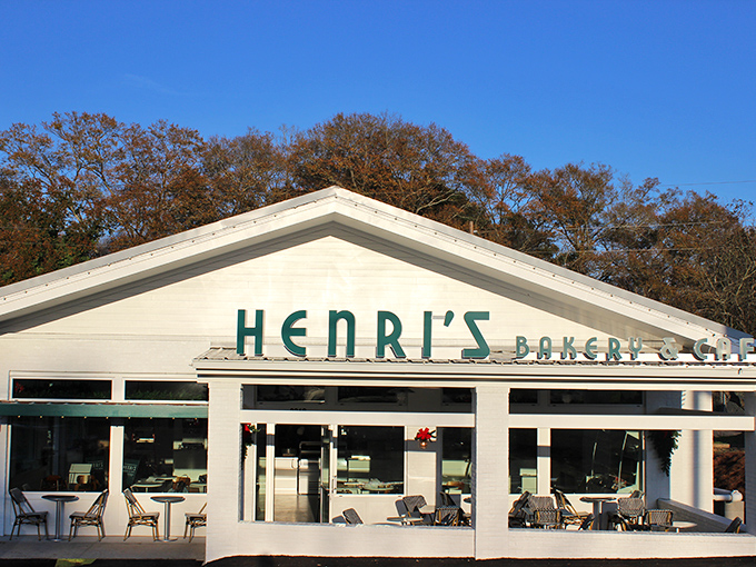 A little slice of heaven with green umbrellas providing shade as diners enjoy their meal on Henri's inviting outdoor patio. The perfect urban oasis.
