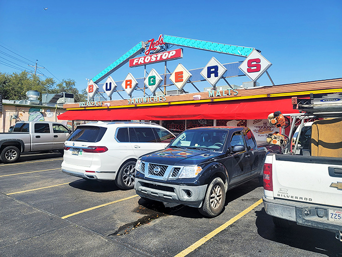 The iconic Frostop sign beckons like a neon lighthouse for the hungry, promising classic American comfort in the heart of New Orleans.