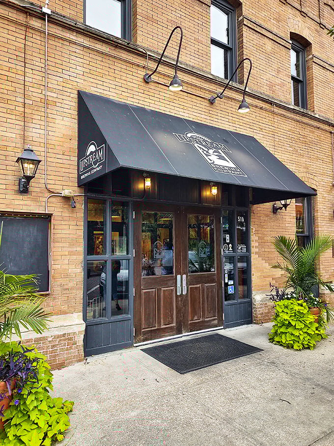 The historic brick facade of Upstream Brewing Company stands proudly in Omaha's Old Market, its former firehouse identity preserved with architectural integrity and charm.