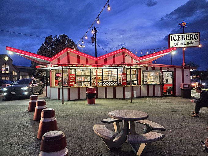 The iconic red and white striped exterior of Iceberg Drive Inn stands like a time capsule on 3900 South, promising nostalgic delights within.