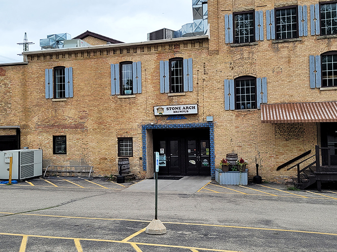 Stone Arch Brewpub's historic brick exterior with blue shutters stands as Appleton's answer to "where should we eat tonight?" Timeless charm meets modern craft brewing.