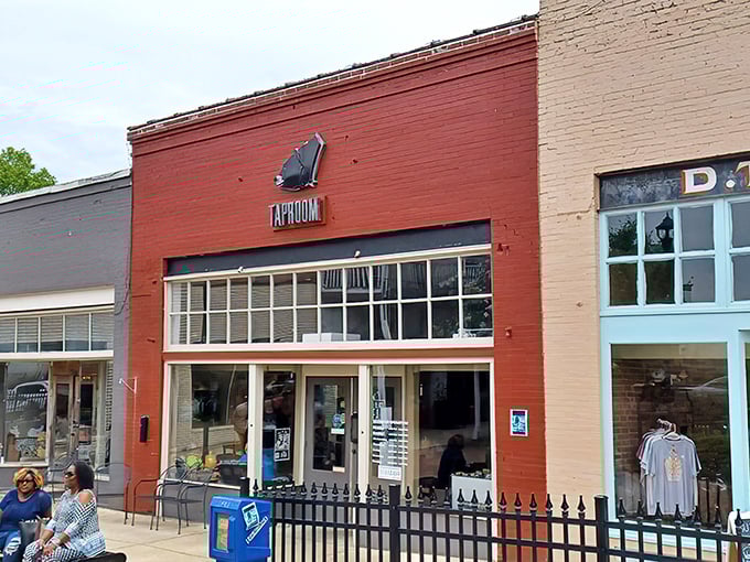 The bright red brick exterior of Old Black Bear's taproom stands as a beacon of culinary promise in historic downtown Madison.