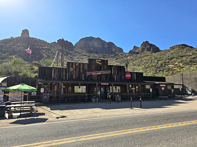 The weathered wooden facade of Tortilla Flat Saloon stands defiantly against time, a slice of the Wild West complete with authentic frontier charm and a Coca-Cola sign that's seen it all.