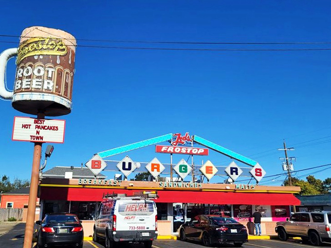 The iconic Frostop sign beckons like a neon lighthouse for the hungry, promising classic American comfort in the heart of New Orleans. 