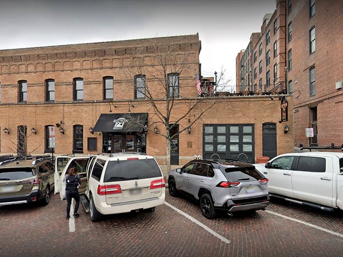The historic brick facade of Upstream Brewing Company stands proudly in Omaha's Old Market, its former firehouse identity preserved with architectural integrity and charm.