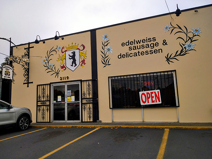 The iconic cream-colored exterior of Edelweiss, with its charming alpine flower logo, stands as Portland's beacon of German culinary tradition.