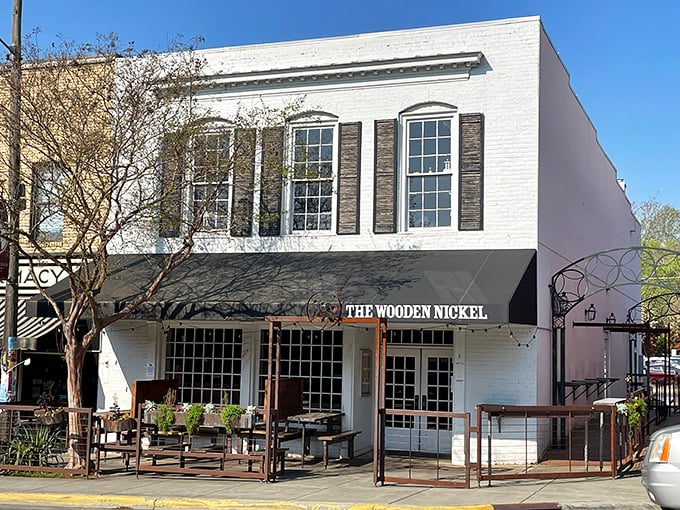 The Wooden Nickel's classic white facade stands proudly on Hillsborough's King Street, beckoning hungry travelers with the promise of comfort and conversation.