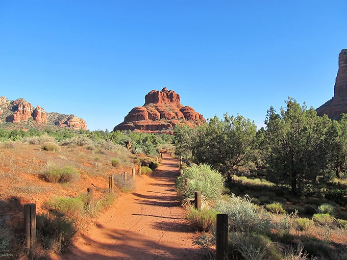 Nature's red carpet rolls out before you, leading to Bell Rock's majestic silhouette against that impossibly blue Arizona sky.