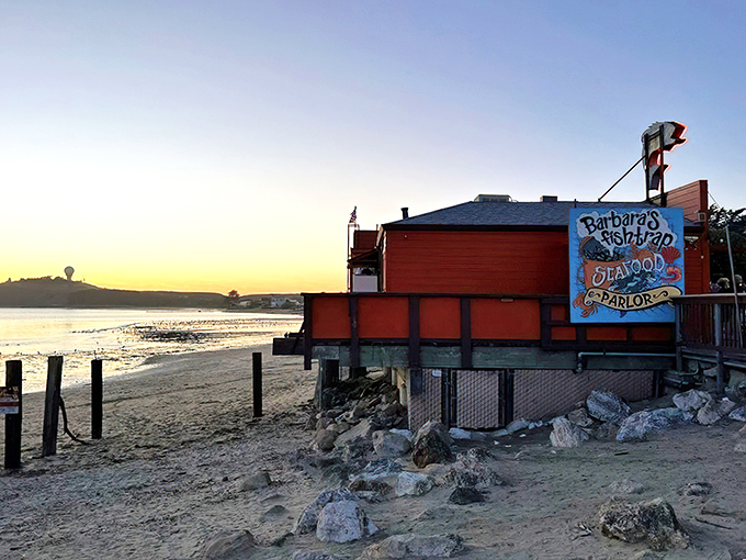 The iconic orange-red exterior of Barbara's Fishtrap stands like a delicious mirage against the Half Moon Bay coastline, complete with a whimsical fish sign that's practically winking at hungry passersby.