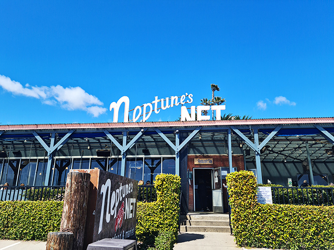 Where motorcycles meet the sea: Neptune's Net stands proudly along PCH, a weathered wooden beacon for hungry travelers and weekend riders alike.