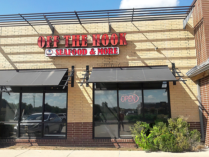 The bright red signage against tan brick promises seafood salvation in a landlocked state. Oklahoma's coastal embassy awaits.