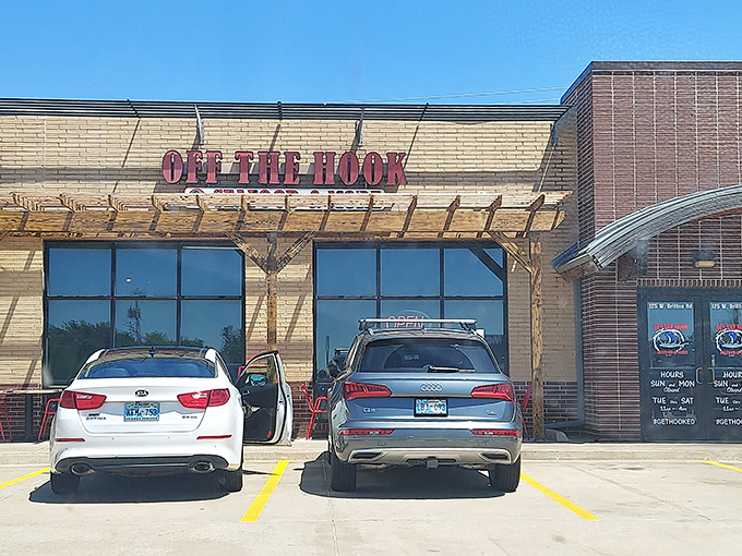 The bright red signage against tan brick promises seafood salvation in a landlocked state. Oklahoma's coastal embassy awaits.
