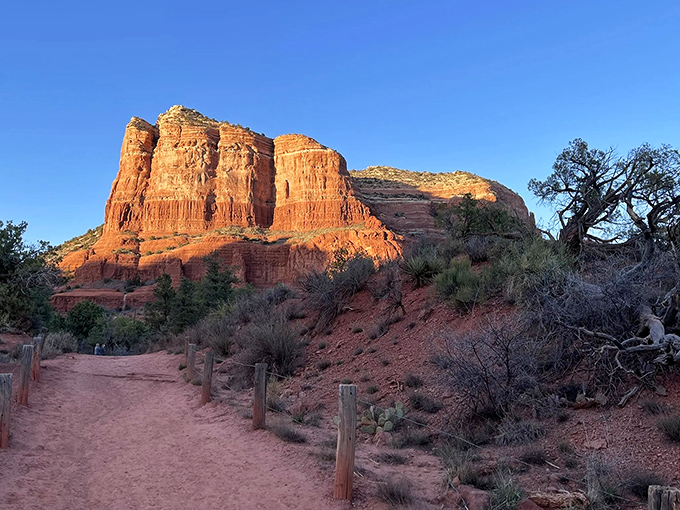 Nature's red carpet rolls out before you, leading to Bell Rock's majestic silhouette against that impossibly blue Arizona sky.