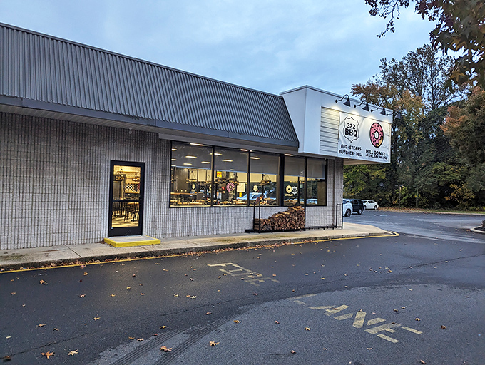 The pink donut sign beckons like a sugar-dusted lighthouse, guiding hungry travelers to this unassuming strip mall treasure in Wilmington.