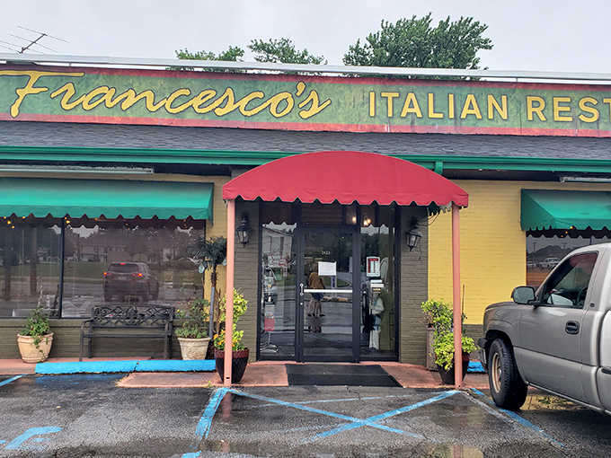 The cheerful yellow exterior with its red and green awnings isn't just inviting—it's practically shouting "authentic Italian food inside!" like a culinary town crier.
