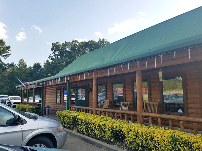 The rustic log cabin exterior of The Oaks isn't trying to impress you&mdash;until you taste what's cooking inside. Green roof, wooden benches, and promises of carnivorous delight await.
