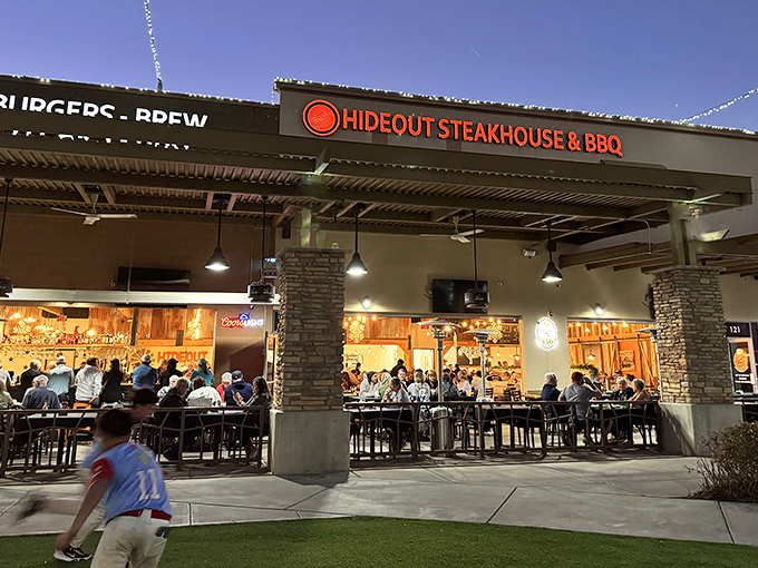 The unassuming exterior of Hideout Steakhouse & BBQ proves once again that culinary treasures often hide in plain sight. Desert dining at its finest awaits inside.