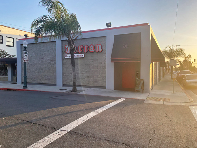 The iconic red Tartan sign beckons like a lighthouse for hungry souls. That bright red door promises culinary adventures within those stone walls.