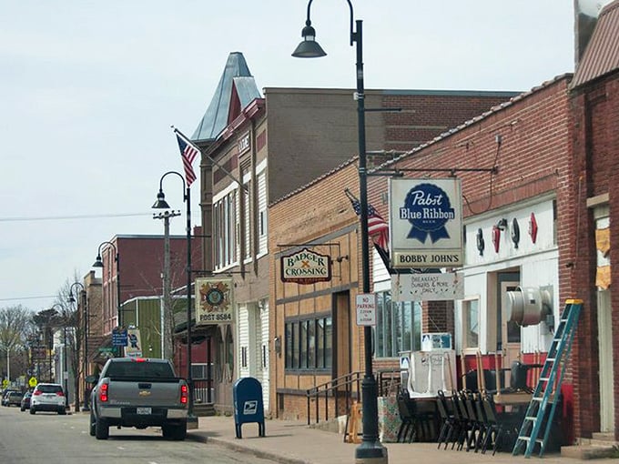 Colorful tiny shops at Down A Country Road create a garden oasis where Amish crafts find their showcase amid blooming flowers and comfortable seating areas.