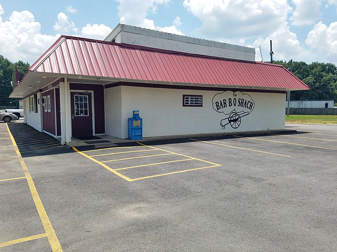 The unassuming exterior hides barbecue greatness like a superhero's secret identity. That yellow sign is Jacksonville's equivalent of the Bat Signal for hungry locals.