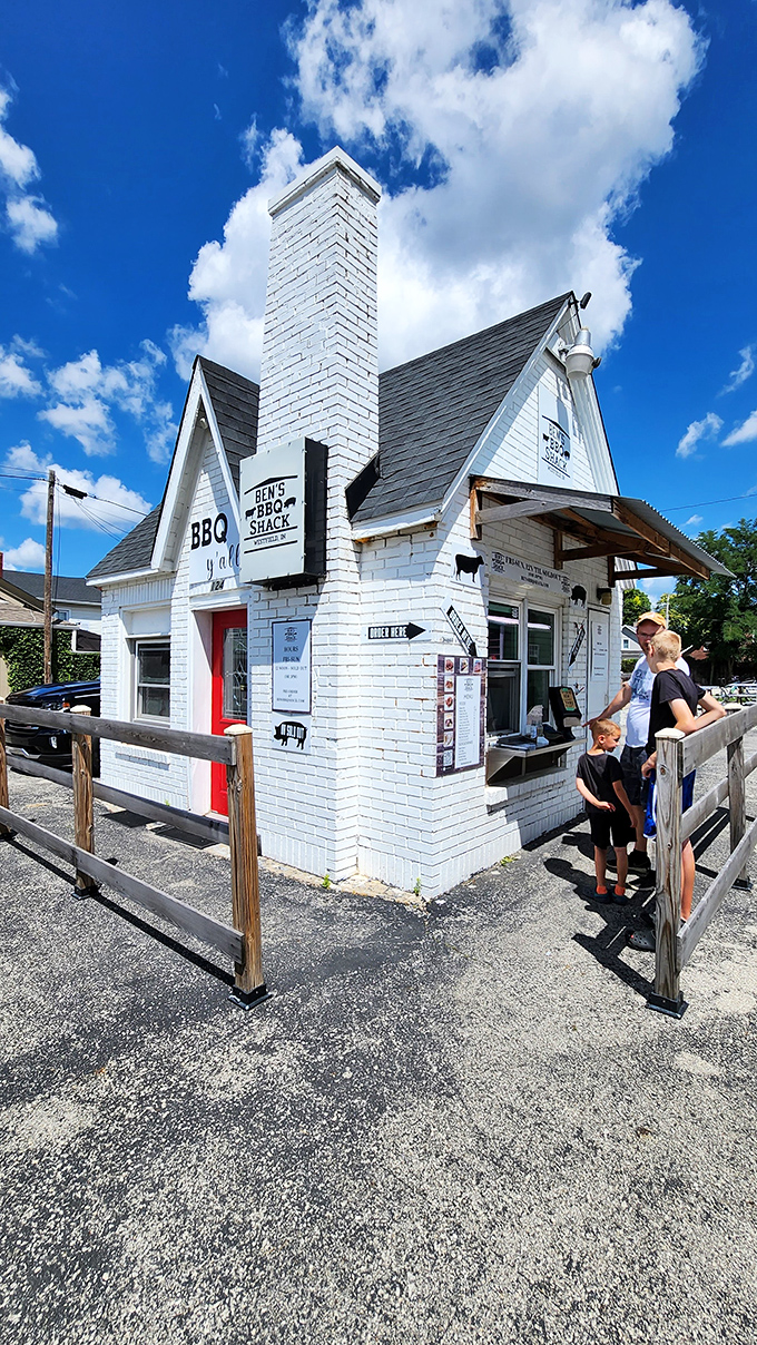 The white brick cottage with its distinctive red door isn't just serving barbecue &ndash; it's serving dreams wrapped in smoke and tucked between bread.