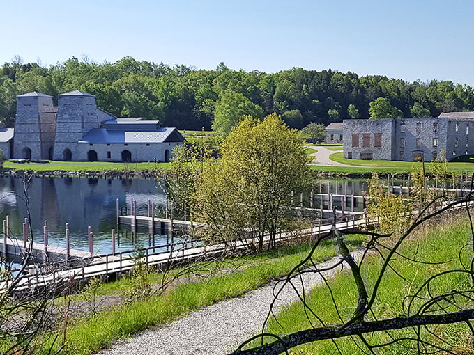 The imposing limestone blast furnaces stand like ancient temples against the azure waters of Snail Shell Harbor, a perfect marriage of industrial history and natural beauty.