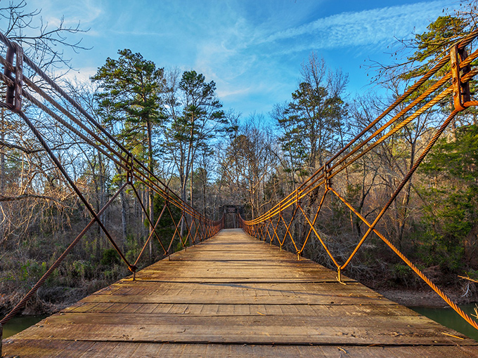Nature's mirror game at its finest. Tishomingo's lake reflects autumn foliage like a master painter showing off, creating a double dose of Mississippi magic.
