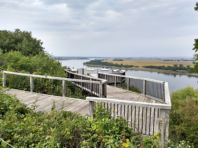 The Missouri River curves gracefully through autumn-painted hills, reminding us that Nebraska's landscape has more plot twists than a good mystery novel.