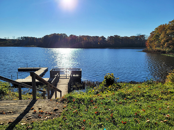 Mirror-like waters reflect autumn's fiery palette at Punderson Lake, where nature doubles its show for free. Mother Nature showing off again!