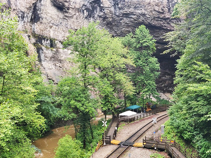Mother Nature's architectural masterpiece frames the railroad tracks like she's showing off a million years of erosion artistry.