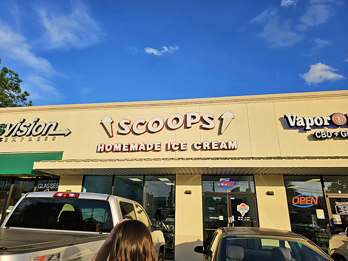 Scoops Homemade Ice Cream stands proudly in Hot Springs, its cheerful yellow facade promising sweet relief from Arkansas summer heat. The "OPEN" sign never looked so inviting.