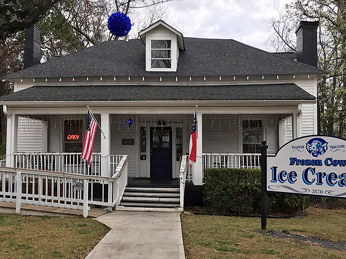 Home sweet ice cream home! This picture-perfect white farmhouse with its inviting porch practically whispers "slow down and treat yourself" to every passerby.